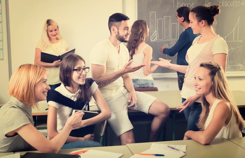 Group of Students Chatting in Classroom Stock Photo - Image of ...