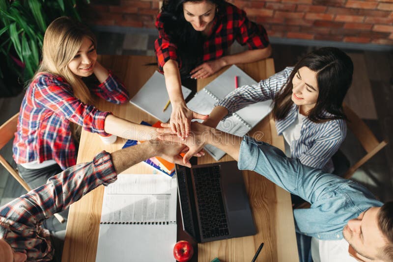 Group of Students Clasped Hands Over the Table Stock Image - Image of ...