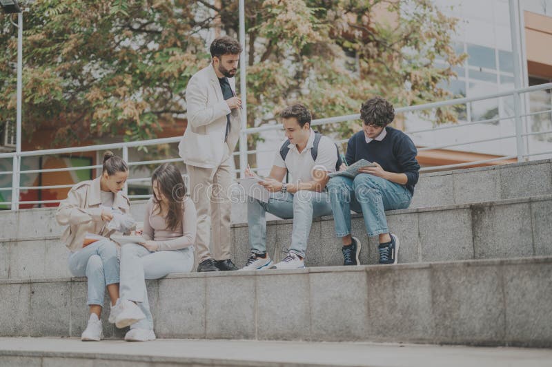 Group of Students Collaborating Outdoors with Supportive Professor ...