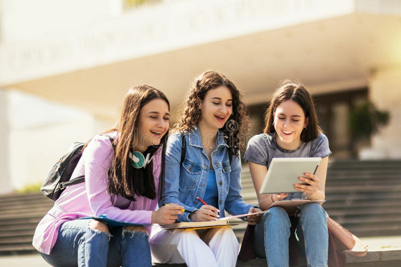 Students with Digital Tablet Studying Together Outdoors Stock Photo ...