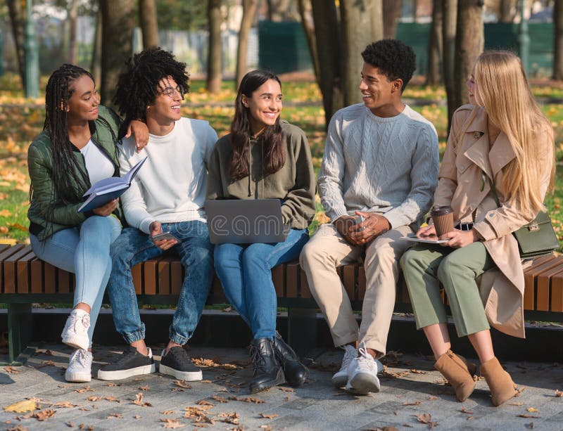 Group of Students Discussing Project, Sitting in Park Stock Image ...