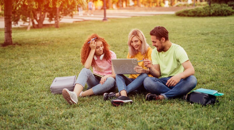 Group of Students Doing Homework in Park Stock Photo - Image of group ...