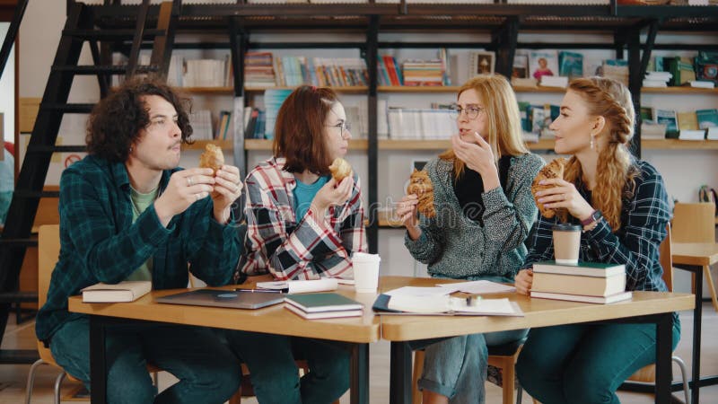 A Group of Students Eat Croissants in Their Free Time from Studying in ...