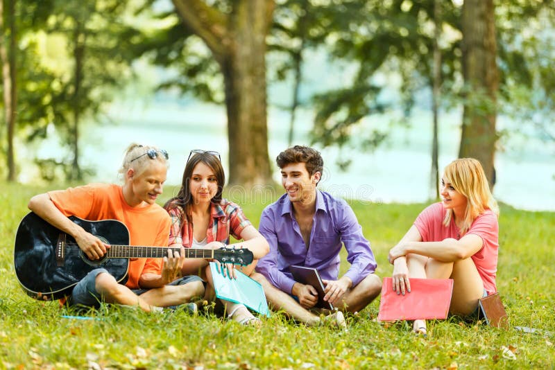 Group of Students with a Guitar Resting in the Park Stock Photo - Image ...