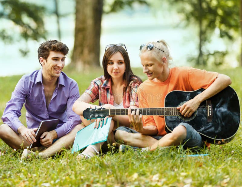 Group of Students with Guitar Resting in the Park on Sunny Stock Image ...