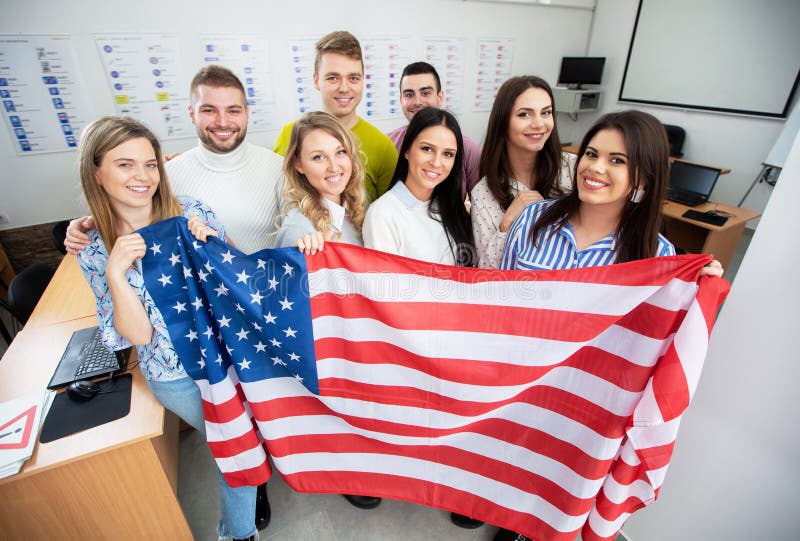 Group of Students Holding an American Flag in the Classroom Stock Photo ...