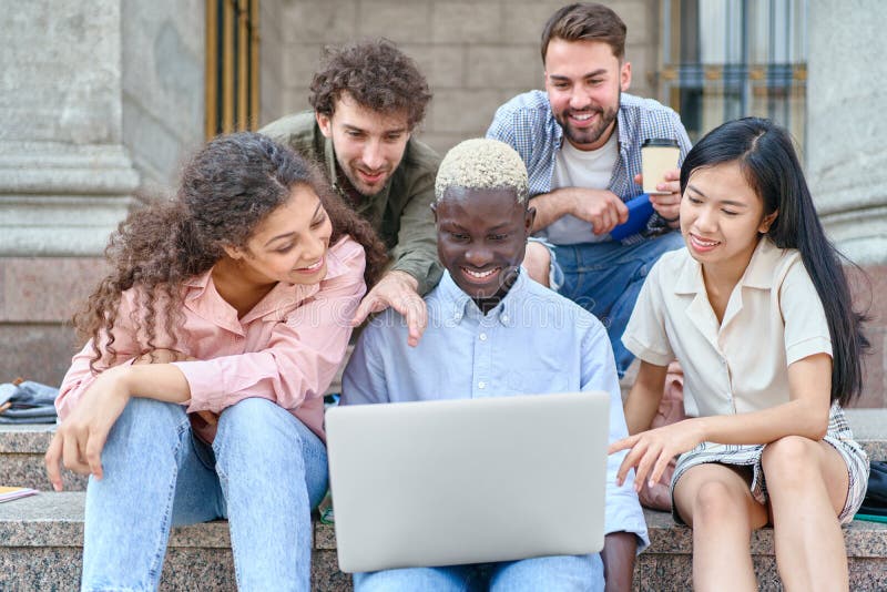 Group of Students with Laptops Sit on the Steps Near the Campus. Stock ...