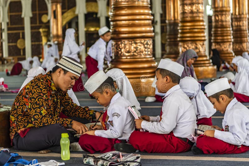 Group of Students Learning To Read Quran with Teachers in a Mosque ...