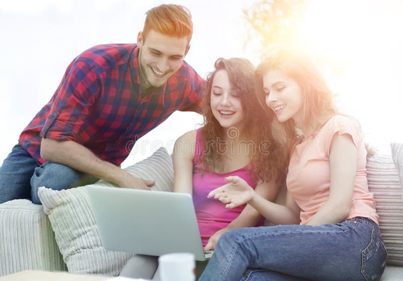 Group of Students Looking at a Laptop Screen,sitting on the Couch Stock ...