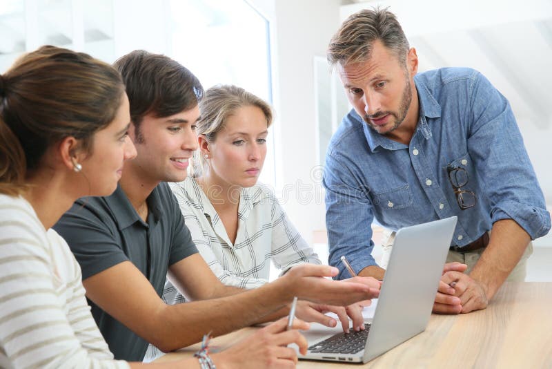 Group of Students with Professor Working on Laptop Stock Image - Image ...