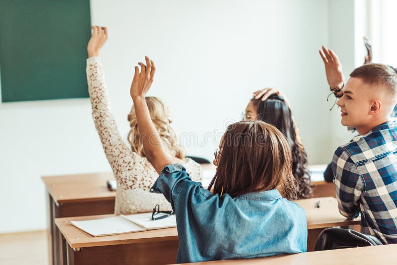 Group of Students Raising Hands in Class Stock Photo - Image of ...
