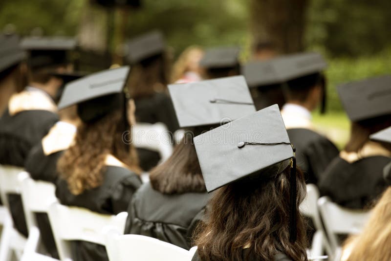 A Group of Students Sit at a Graduation Ceremony, Focus on Mortarboard ...