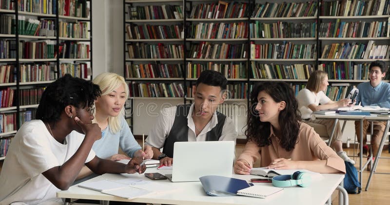 Group of Students Sit in Library with Laptop Writing Essay Stock Video ...