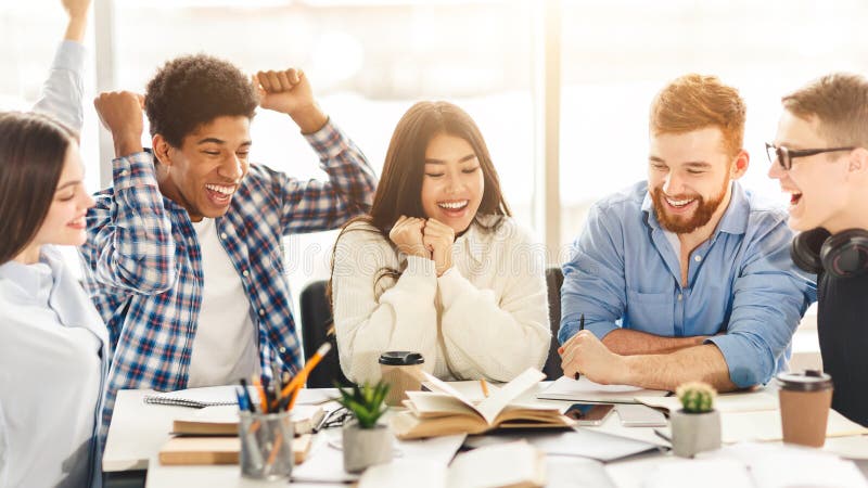 Group of Students Sitting Around Table and Raising Arms Stock Image ...