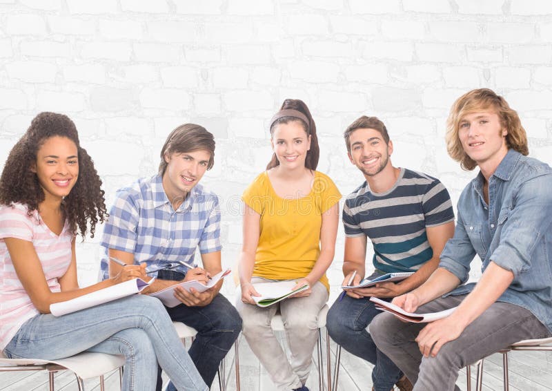 Group of Students Sitting in Front of Brick Grey Background Stock Photo ...