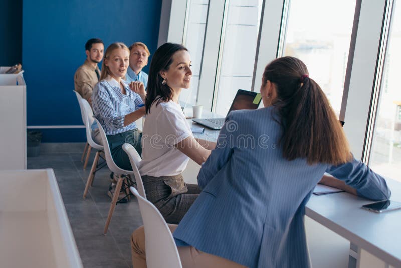 Group of Students Sitting in a Row Together at a Table. Stock Image ...