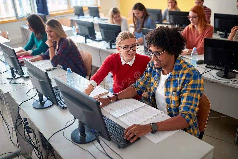 Group of Students Sitting Together at Table Using Computer in Class ...