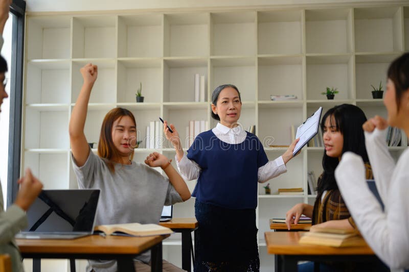 Group of Students and Smiling Mature Professor Celebrating Project ...