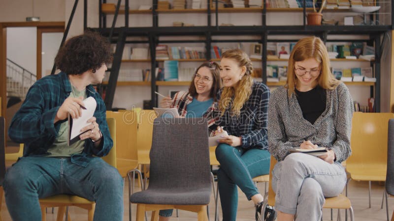 A Group of Students Study and Communicate while Sitting on Chairs in a ...