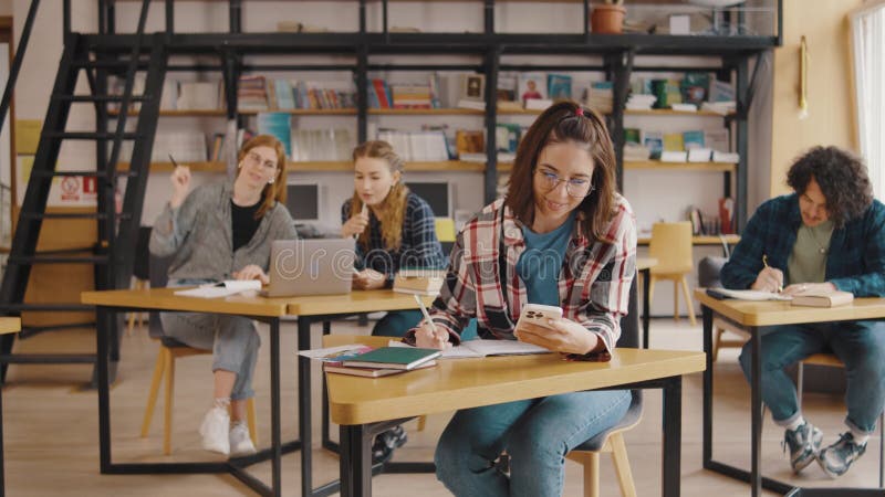 A Group of Students Study and Read Books, Write Information in ...