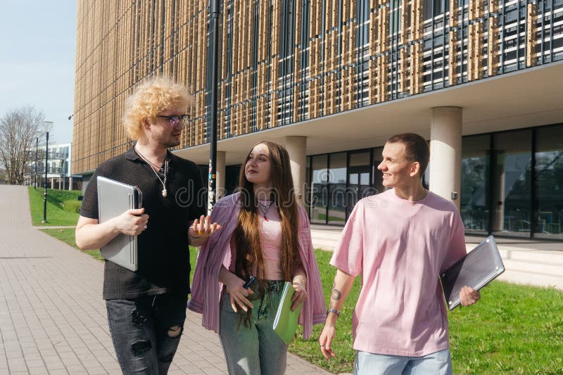 Group of Students Studying and Using Laptops Outside a Modern ...