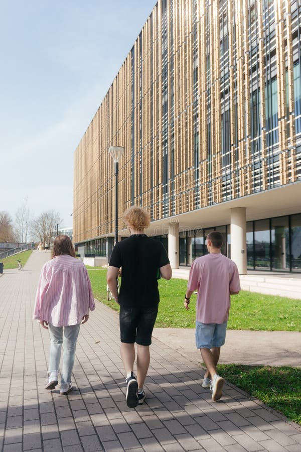 Group of Students Studying and Using Laptops Outside a Modern ...