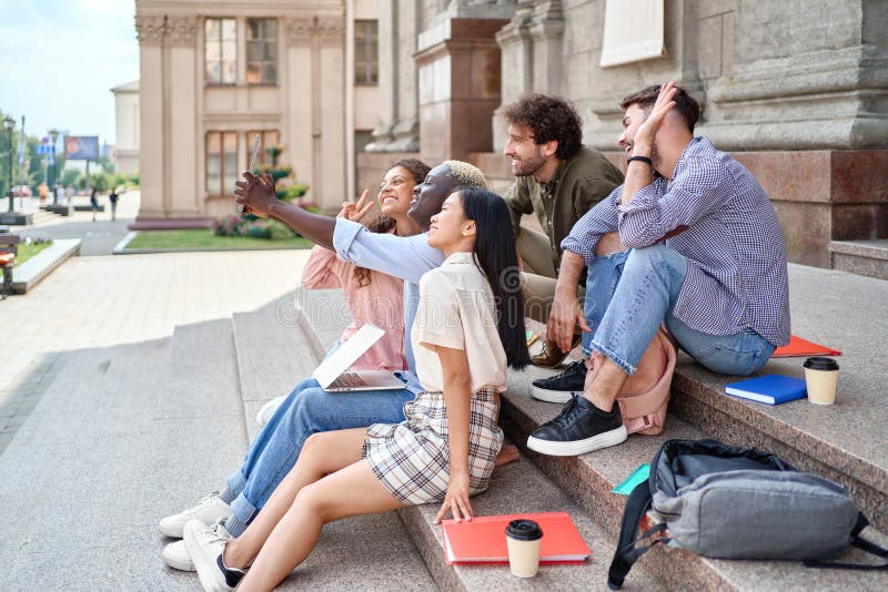 Group of Students Talking on a Video Link Sitting on the Steps. Stock ...