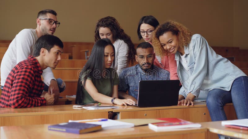 Four Students Work Together on a Group Project in a Classroom Setting ...