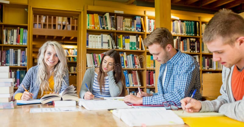 Group of Students Writing Notes at Library Desk Stock Photo - Image of ...
