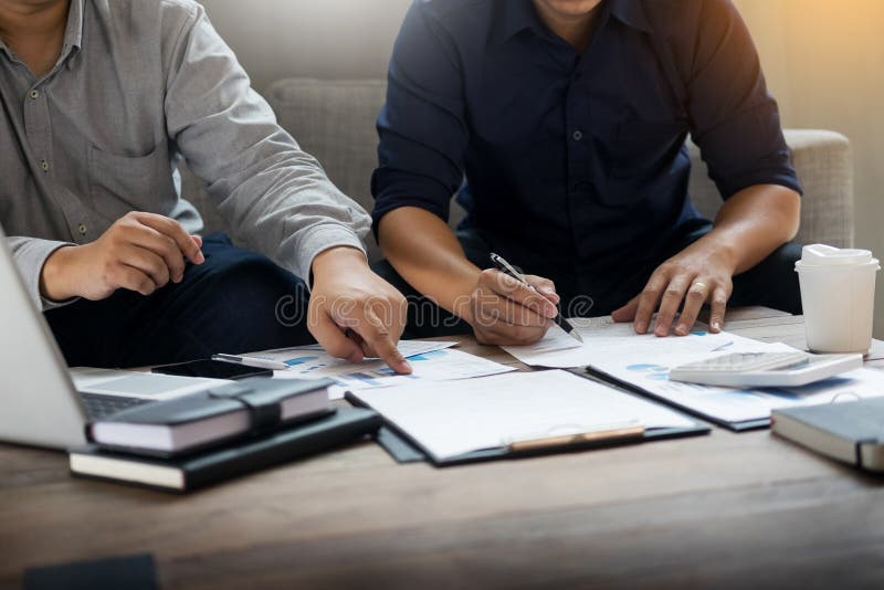 Group of Successful Business People Discussing Paperwork and Using a ...