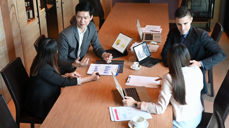 Group of Successful Businesspeople Discussing Business Strategy at ... Group of Successful Businesspeople Discussing Business Strategy at ...