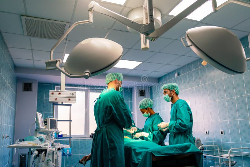 Group of Surgeon Doctor Team at Work in Operating Room. Stock Image ...
