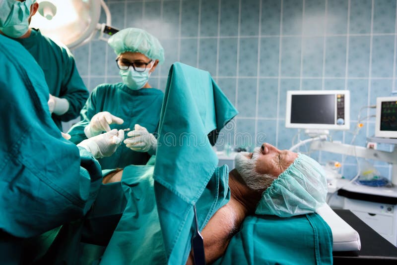 Group of Surgeon Doctor Team at Work in Operating Room. Stock Photo ...