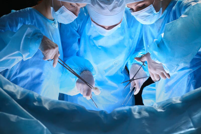 Group of Surgeons at Work in Operating Theater Toned in Blue Stock ...