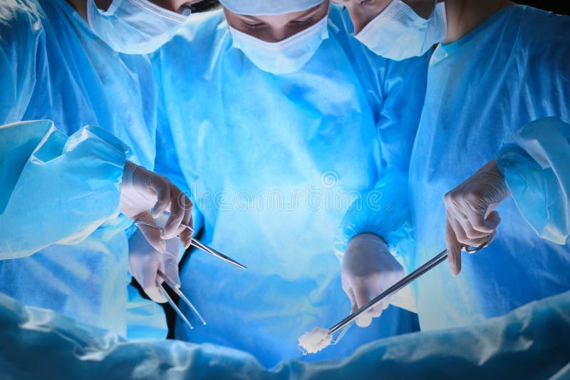 Group of Surgeons at Work in Operating Theater Toned in Blue Stock ...