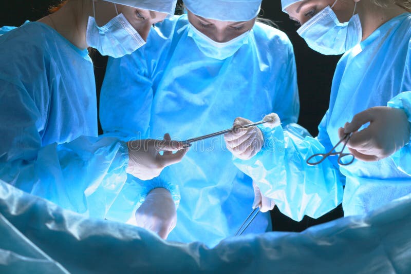 Group of Surgeons at Work in Operating Theater Toned in Blue Stock ...