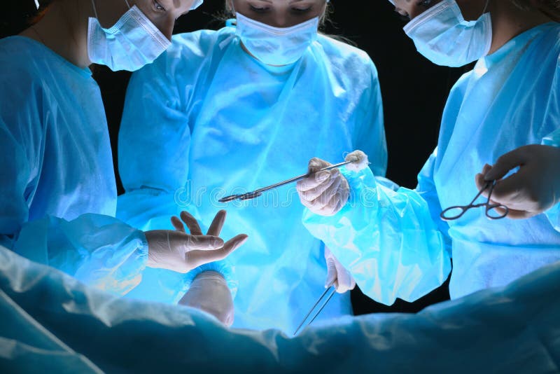 Group of Surgeons at Work in Operating Theater Toned in Blue Stock ...