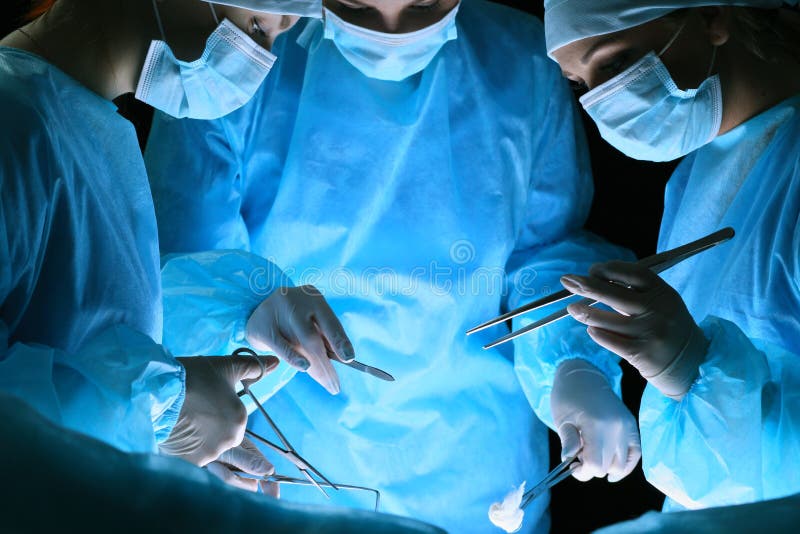 Group of Surgeons at Work in Operating Theater Toned in Blue Stock ...