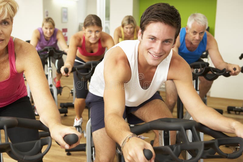 Group Taking Part in Spinning Class in Gym Stock Photo - Image of ...