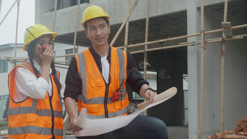 Group Team of Engineer and Architect Holding Blueprint and Explaining ...