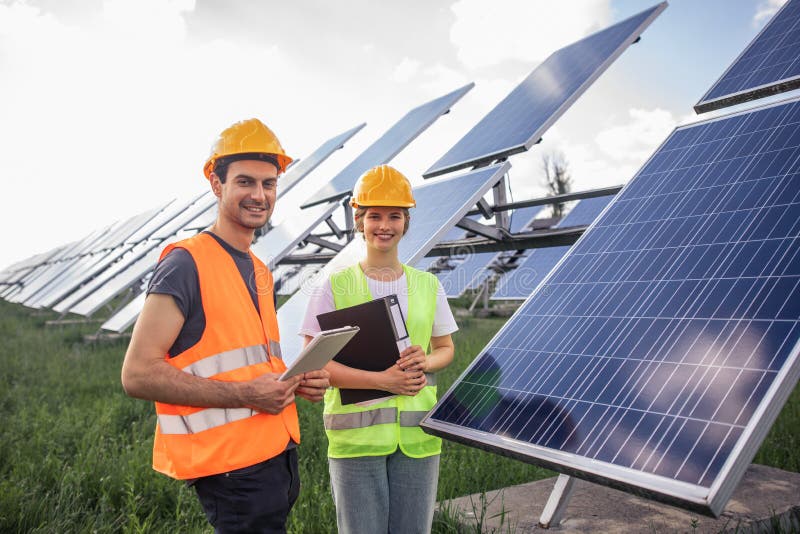 Group of Technicians Engineer at Solar Power Farm Standing in the ...