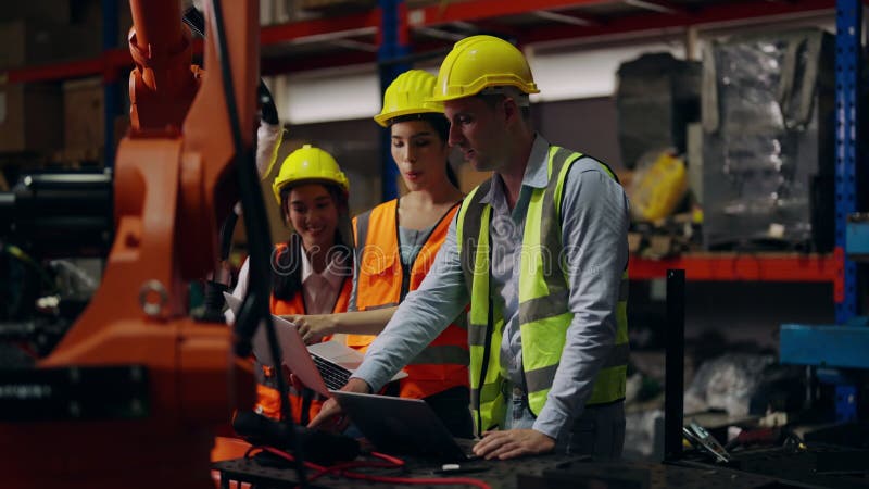Group of Technicians Team Checking and Repairing Robotic Machinery ...