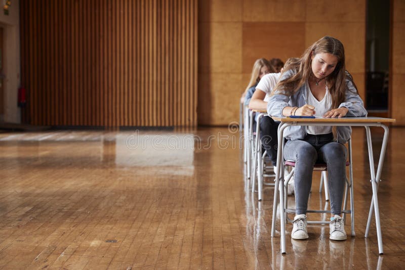 Group of Teenage Students Sitting Examination in School Hall Stock ...