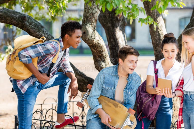 Group of Teenagers Discussing Homework Stock Photo - Image of ...