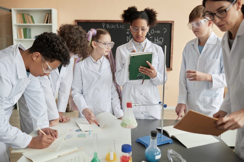 Group of Teens Wearing Lab Coats Enjoying Science Experiments in School ...