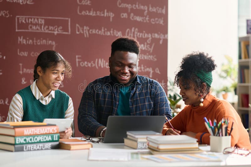 Group of Three Black People in College Class Looking at Laptop Stock ...