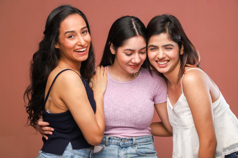 A Group of Three Friends are Posing while Hugging and Smiling Stock ...