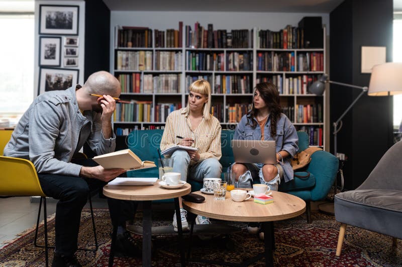 Group of Three Gen Z University Students Working Together at Laptop ...