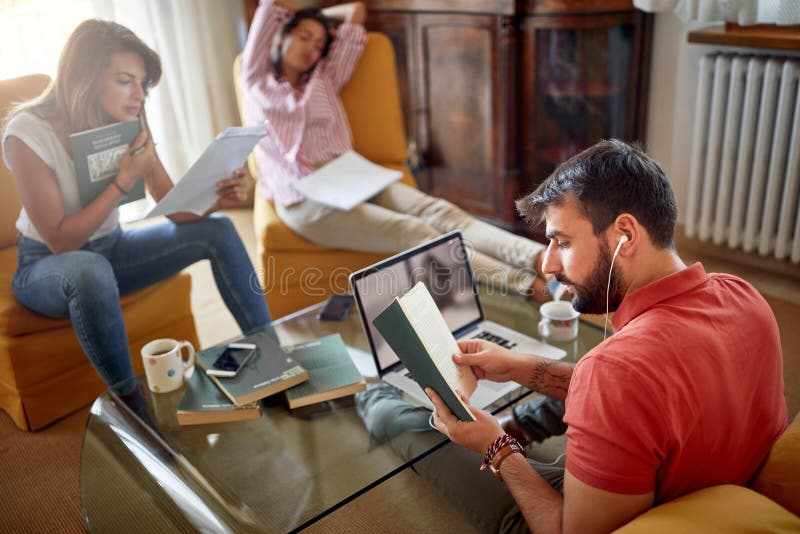 Group of Three Students Writing Paper Together Stock Photo - Image of ...