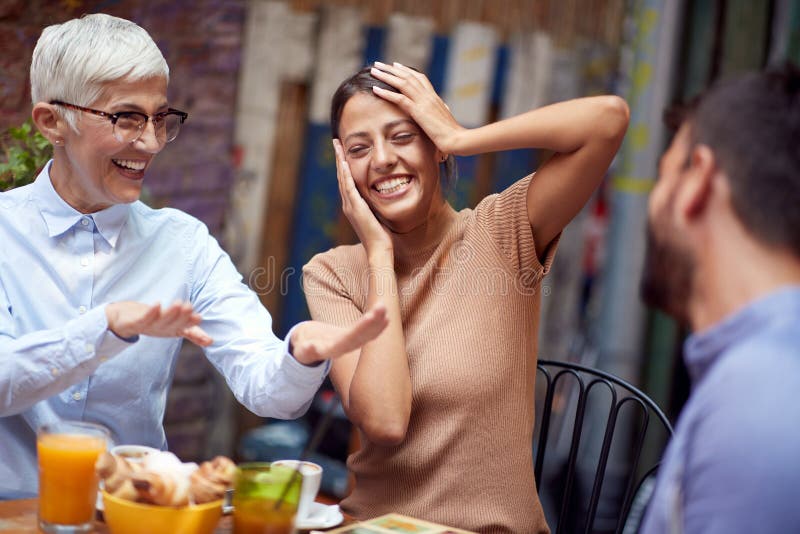 Group of Three, Two Women and One Man, Having Funny Conversation ...